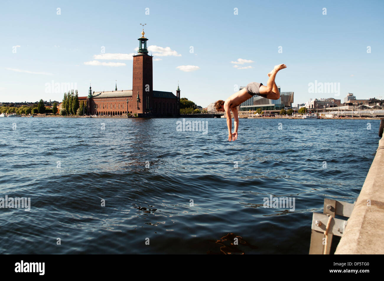 Man jumping into water hi-res stock photography and images - Alamy