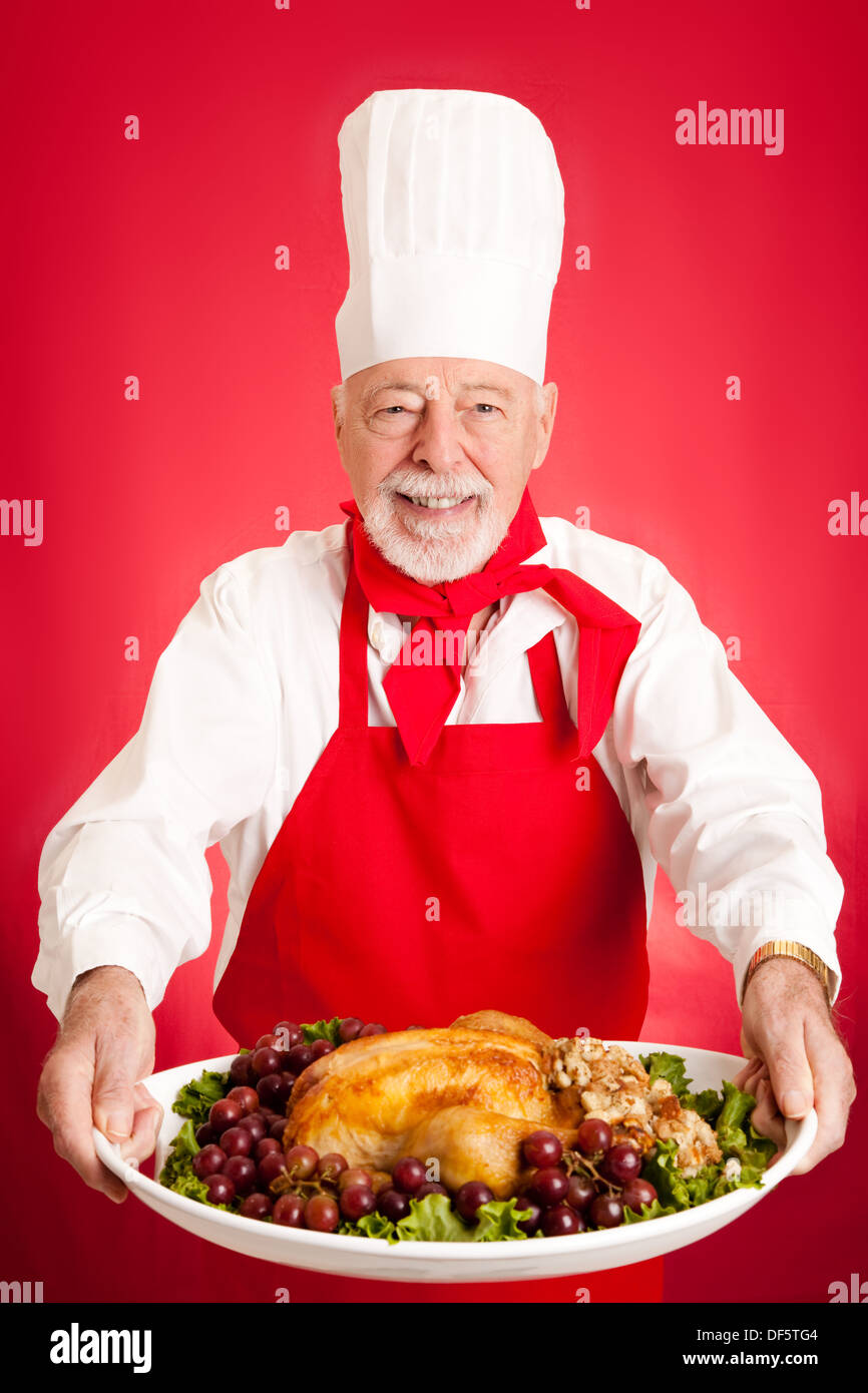 Chef serves beautiful stuffed turkey garnished with grapes. Could also ...