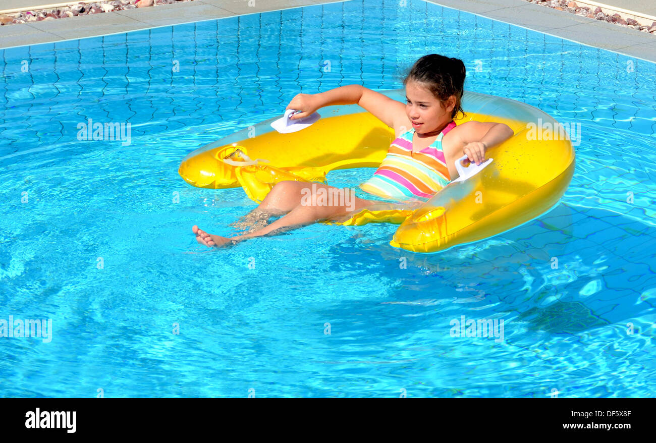 Teenager floats in pool hi-res stock photography and images - Alamy