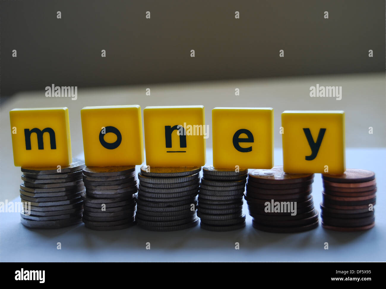 stacks of coins showing the word money Stock Photo - Alamy