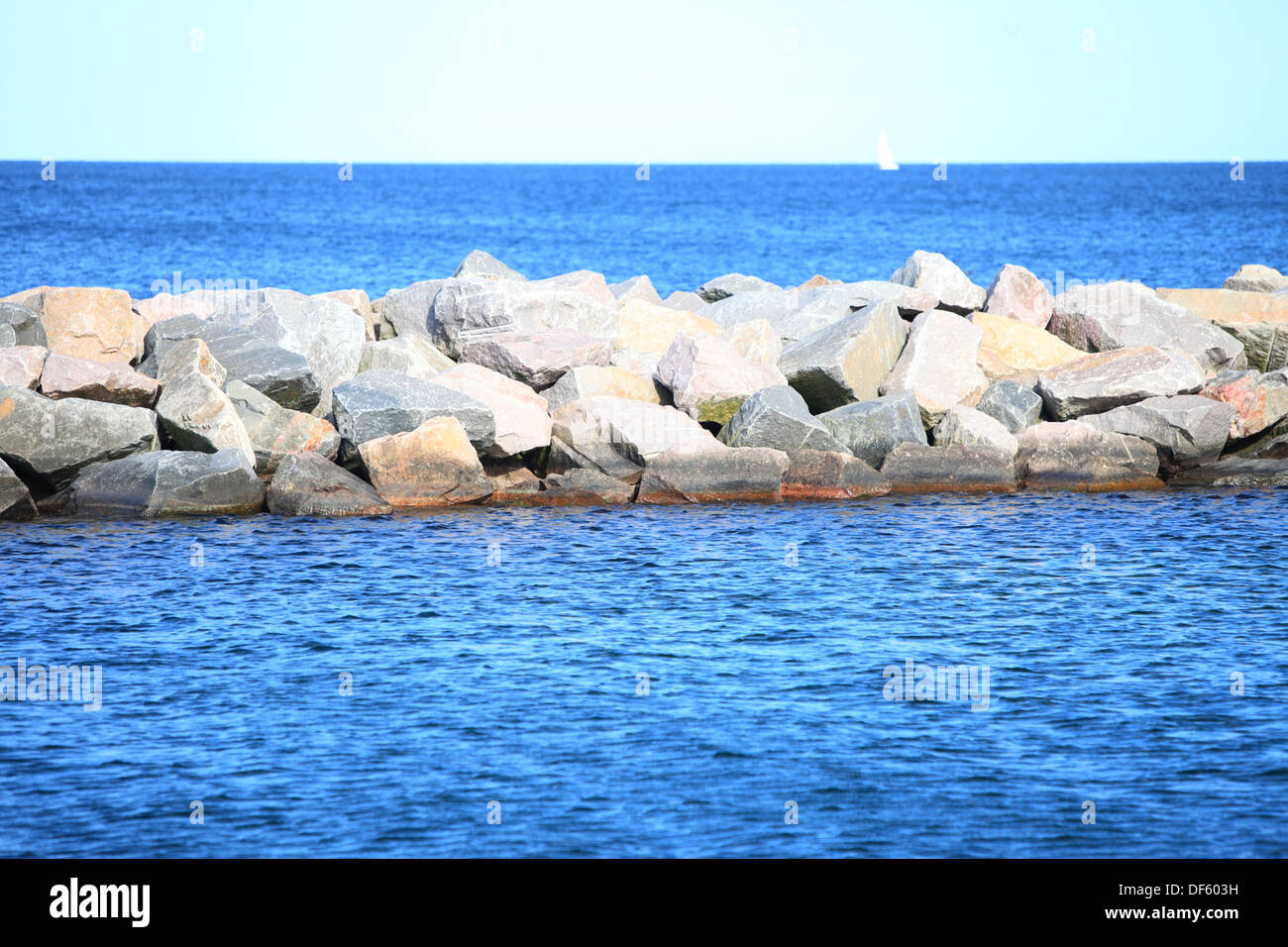 Stone breakwater seawall for protection of coast Stock Photo - Alamy