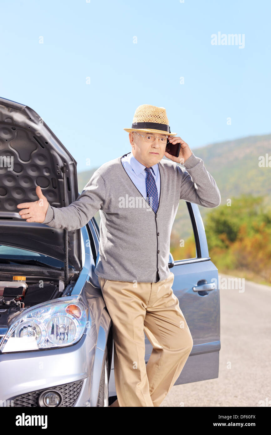 Nervous senior man on a broken car talking on a phone Stock Photo - Alamy