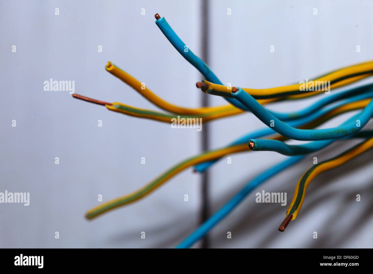 Electrical installation. Close up electric wires hanging on wall ...