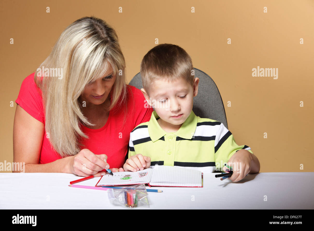 mother and son drawing together, mom helping with homework daycare ...