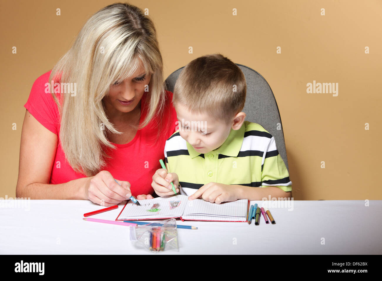 mother and son drawing together, mom helping with homework daycare ...