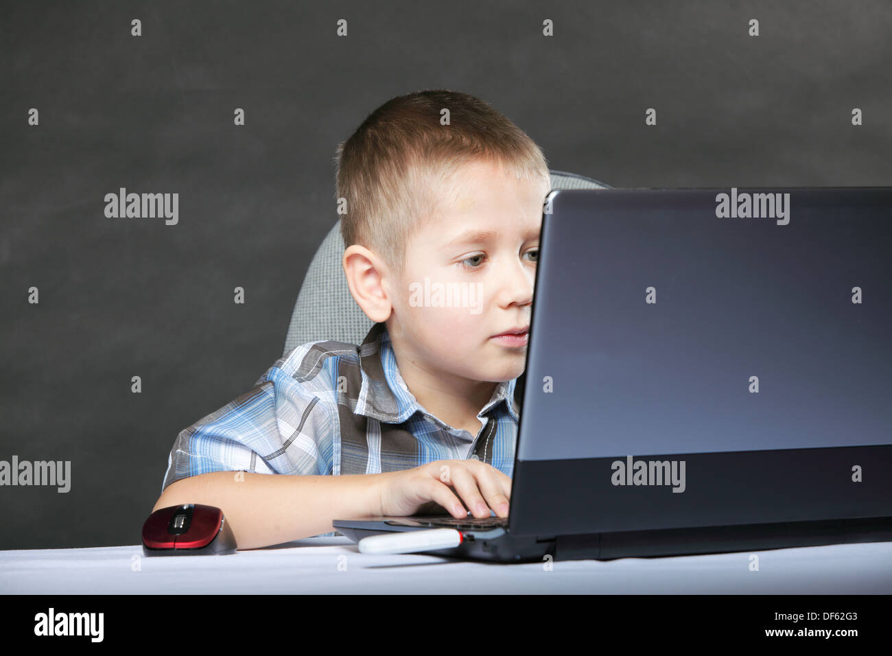 Computer addiction child boy with laptop notebook black background ...