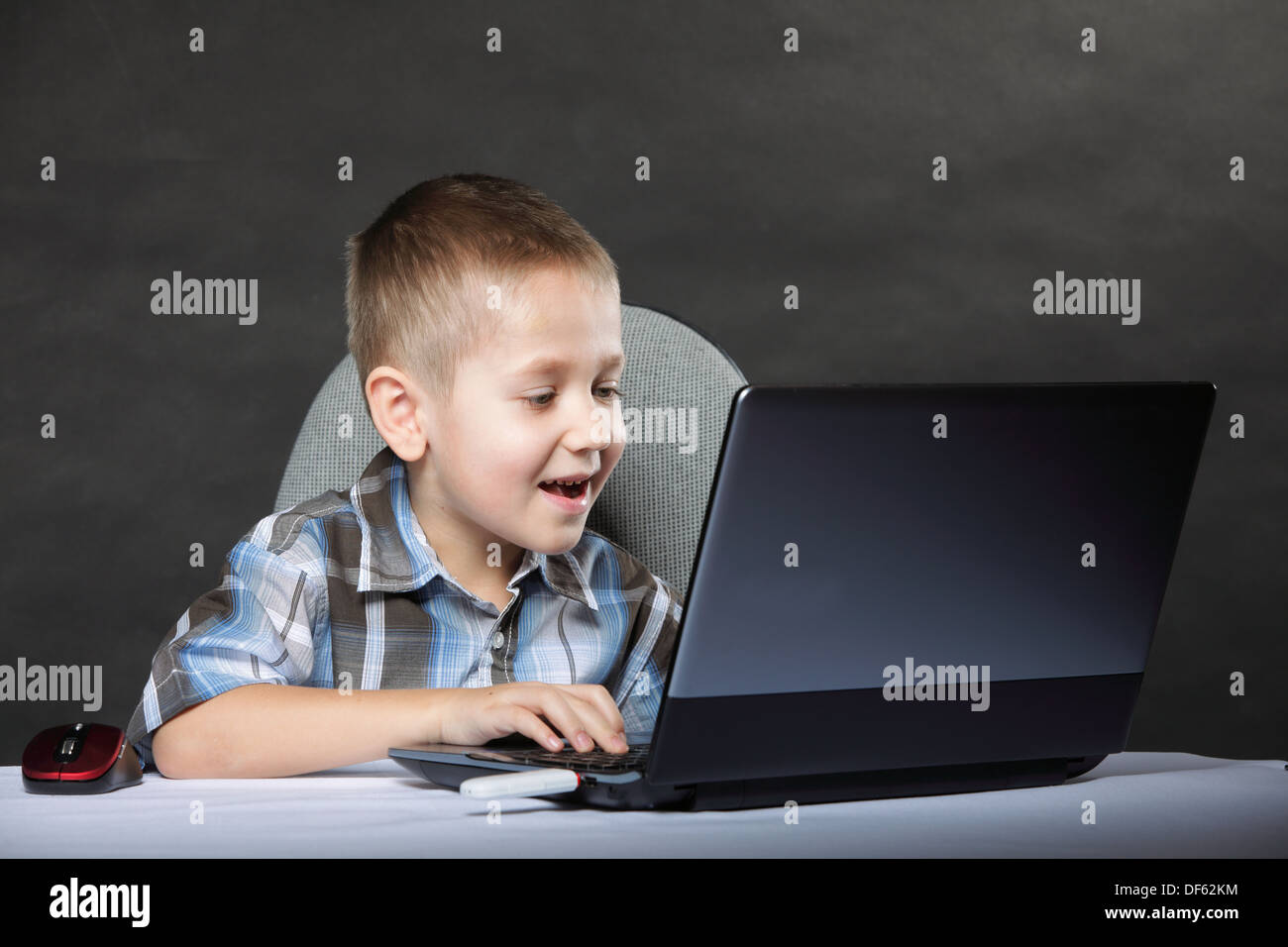 Computer addiction child boy with laptop notebook black background ...