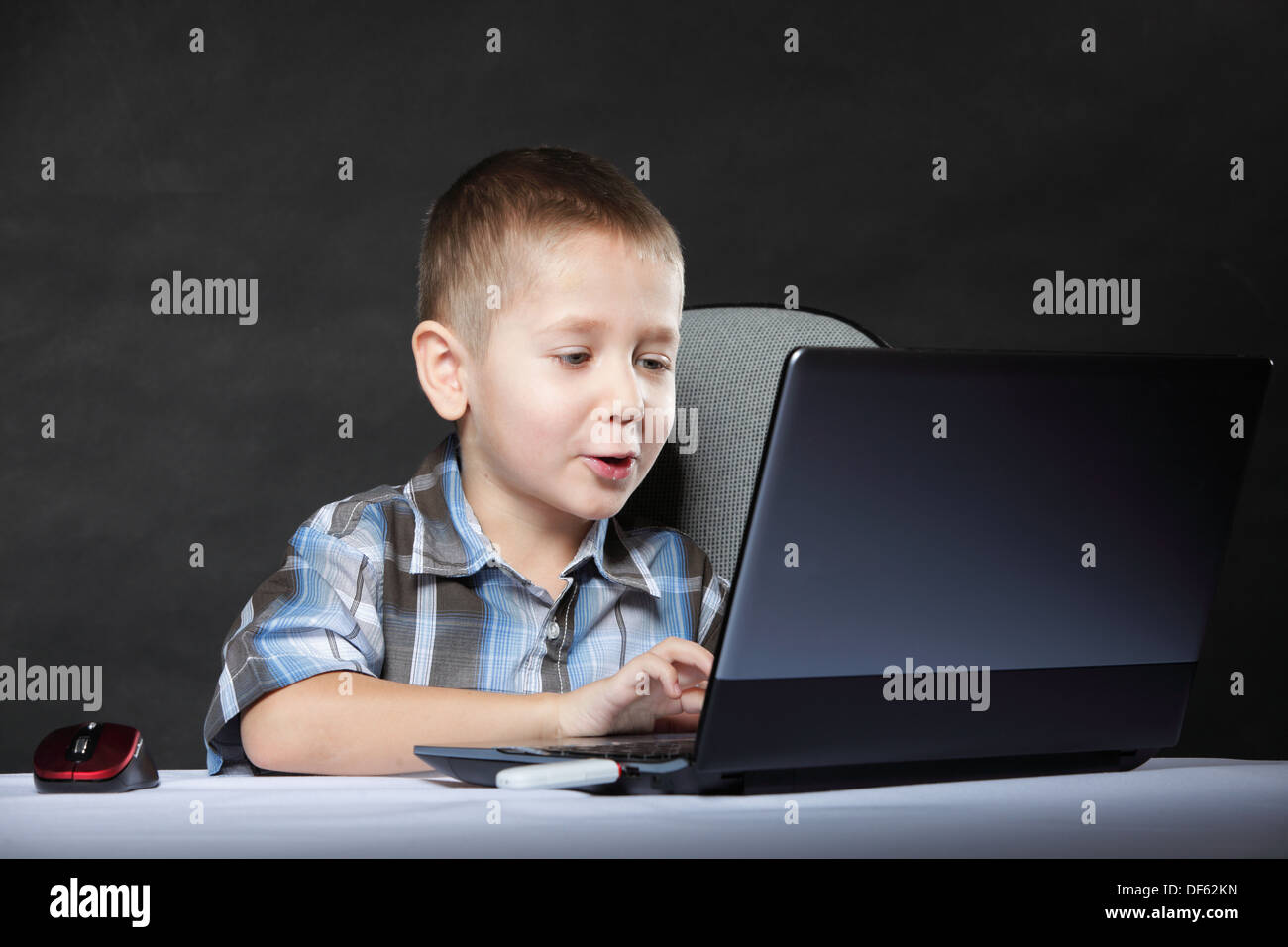 Computer addiction child boy with laptop notebook black background ...