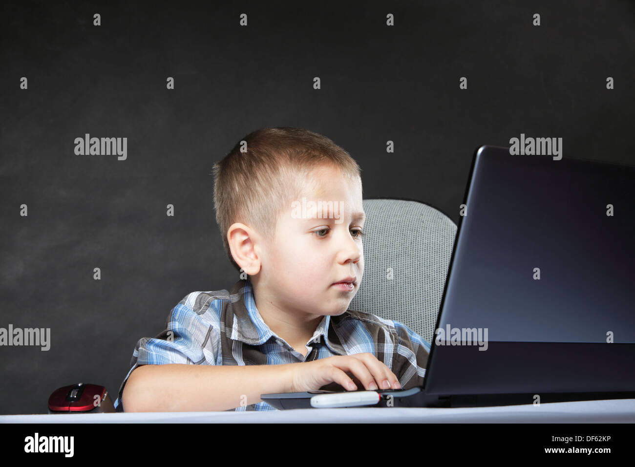 Computer addiction child boy with laptop notebook black background ...