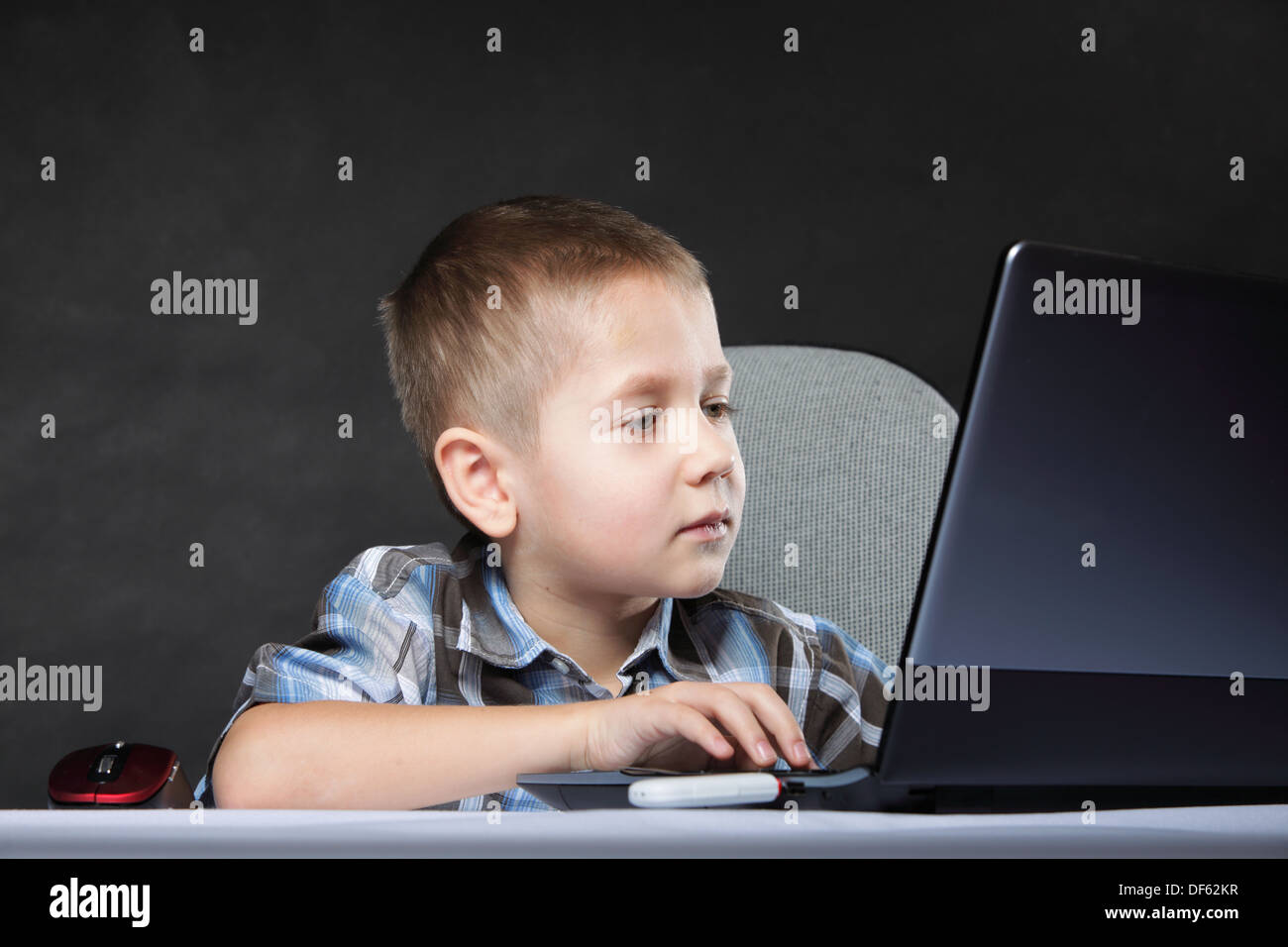 Computer addiction child boy with laptop notebook black background ...