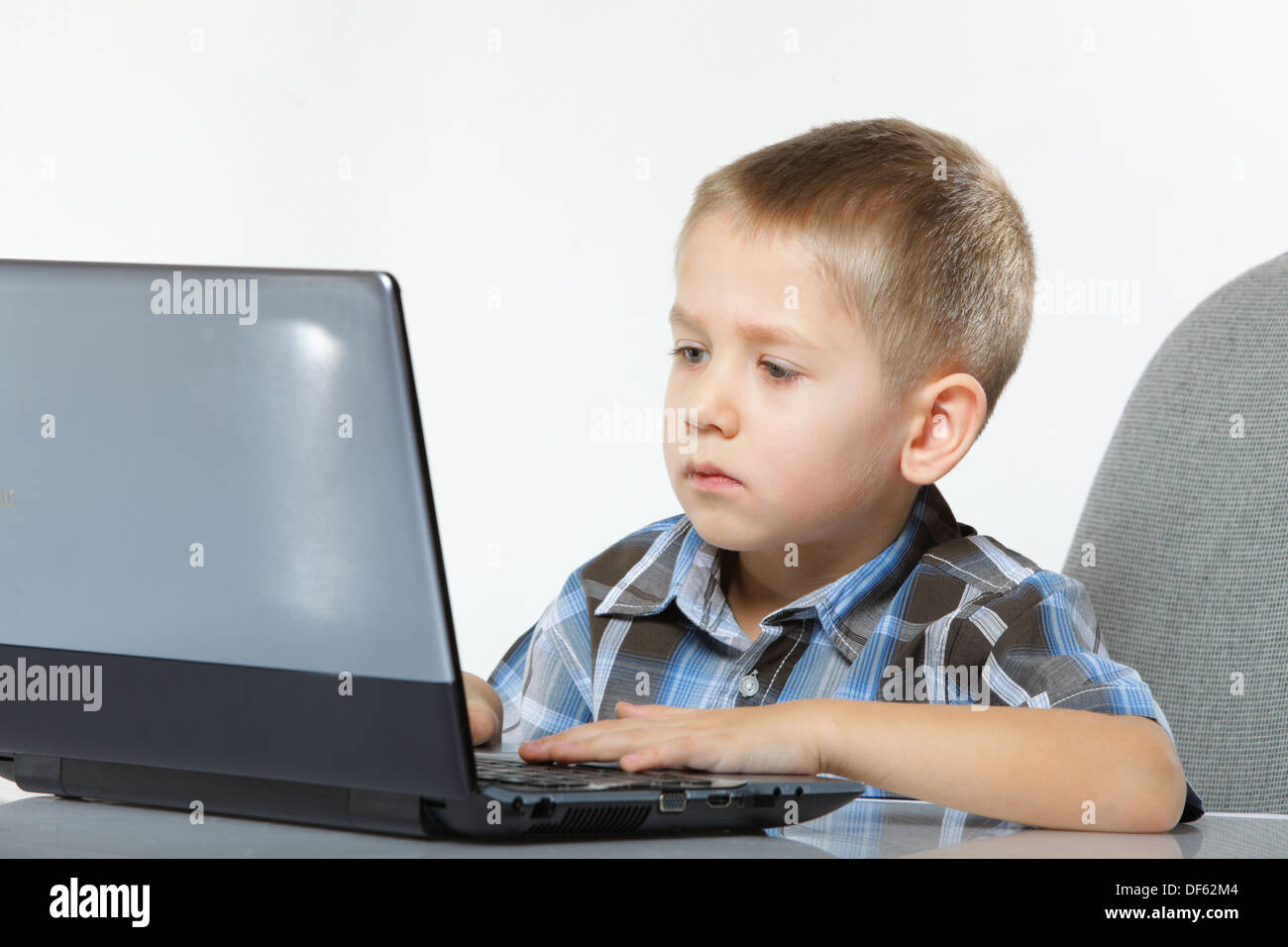 Computer addiction child boy with laptop notebook white background ...