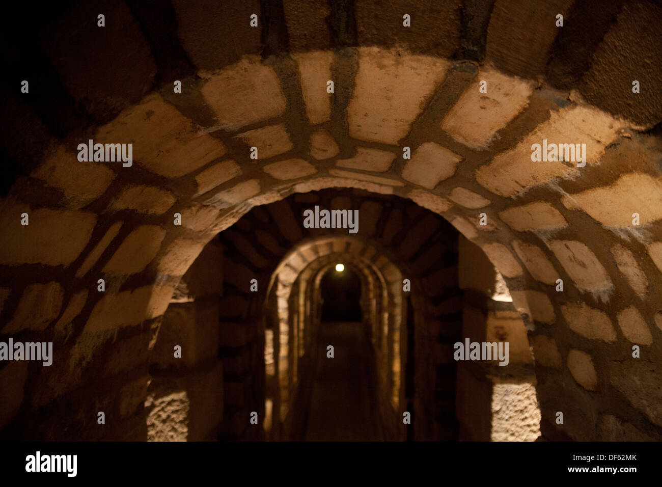 An underground tunnel in the Paris Catacombs, an underground cemetery ...
