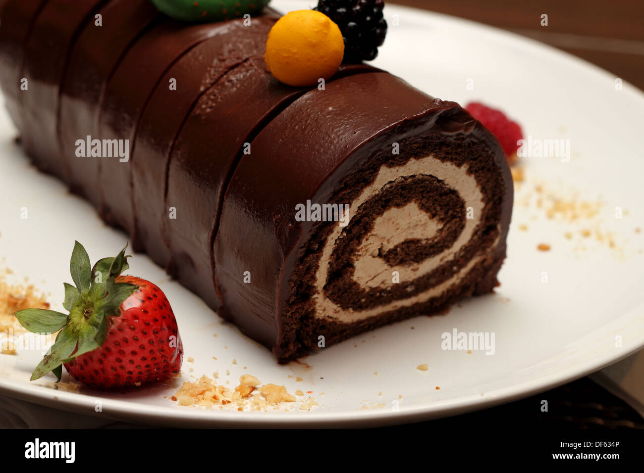 A piece of mini chocolate log cake with strawberry Stock Photo - Alamy