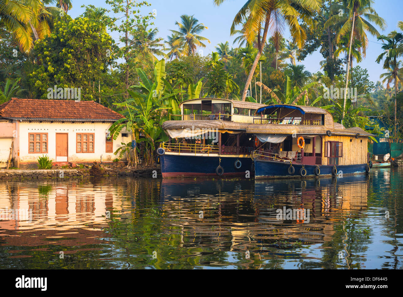 reflection houseboat and house in kerala backwaters, India Stock Photo ...