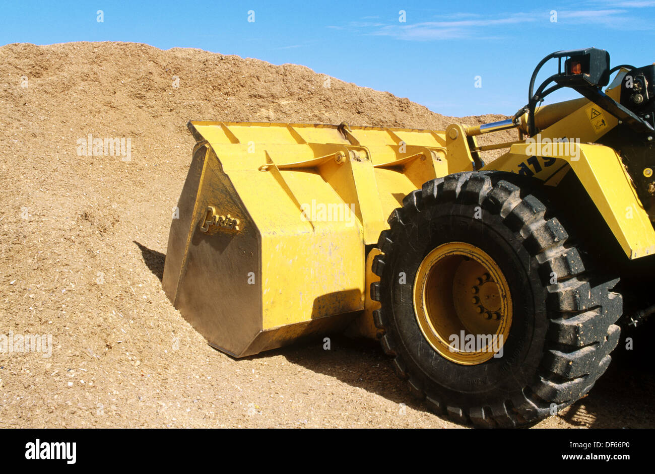 Bucket loaded and pile of various wood chips Stock Photo - Alamy