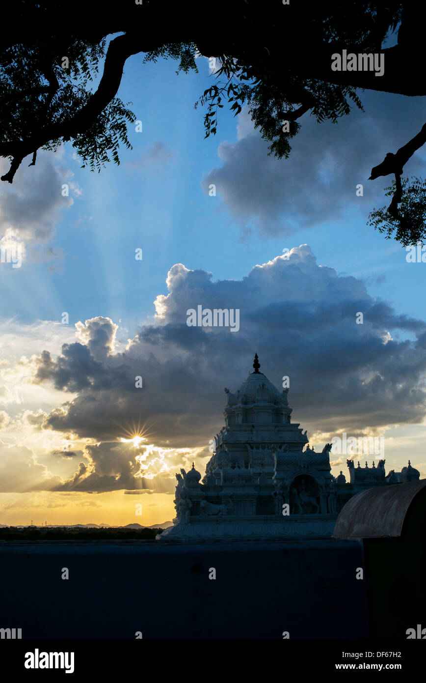 Rural Indian village hindu temple against a sunset cloudy sky. Andhra ...