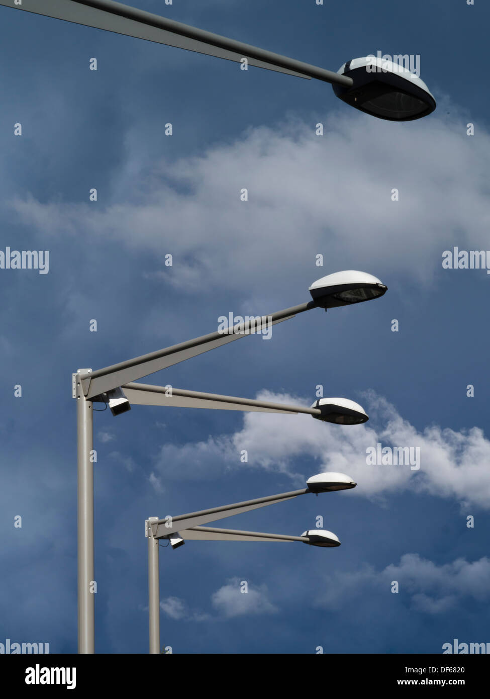Lampposts, street lights set against a gloomy, cloudy sky Stock Photo ...
