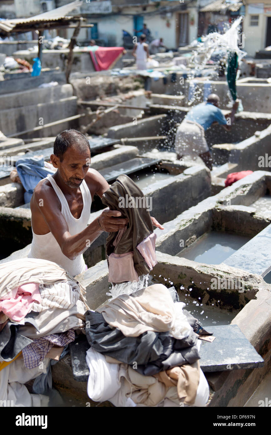 Indian man washing clothes at Mahalaxmi Dhobi Ghat or laundromat Mumbai ...