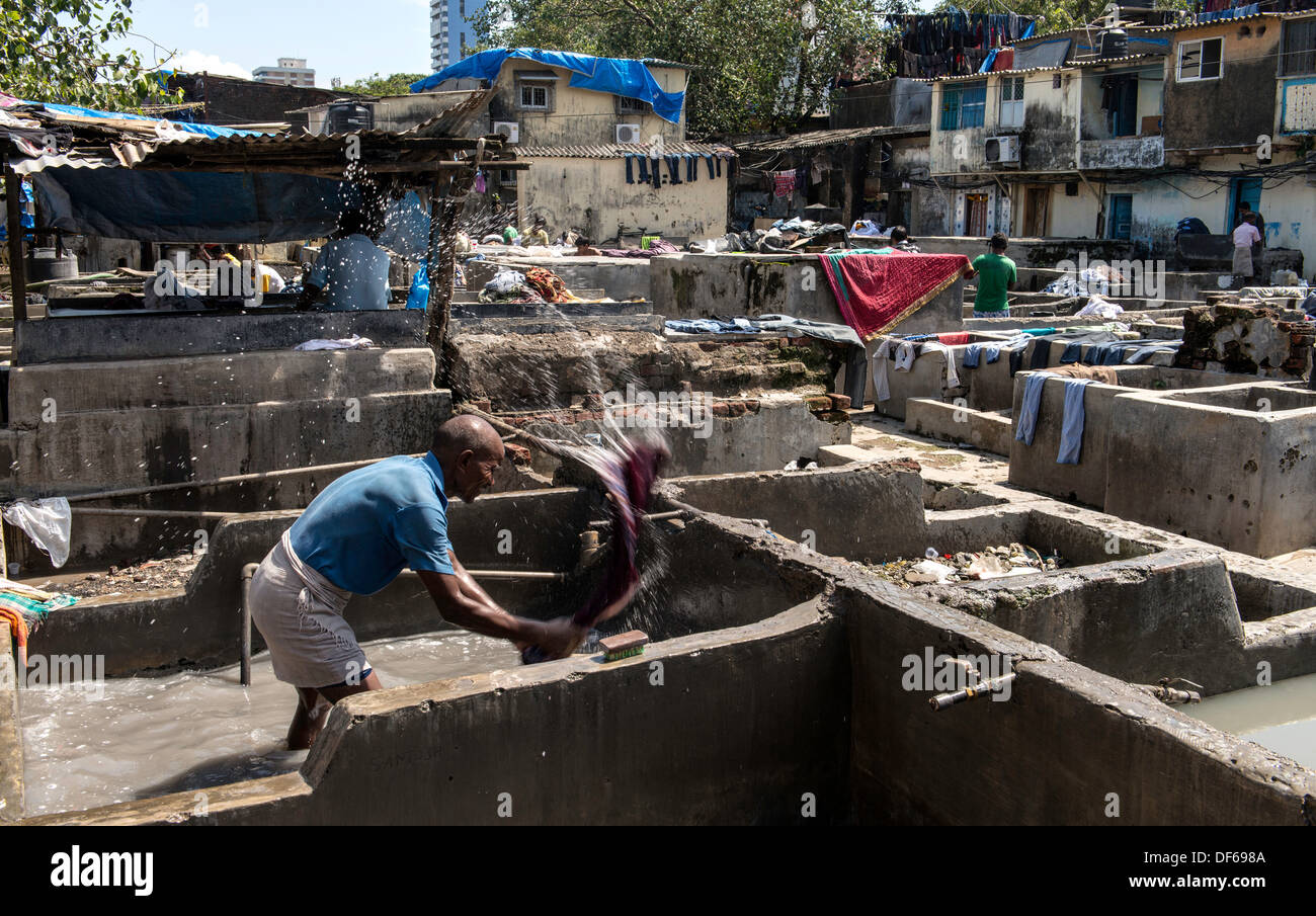 Indian man washing clothes at Mahalaxmi Dhobi Ghat or laundromat Mumbai ...