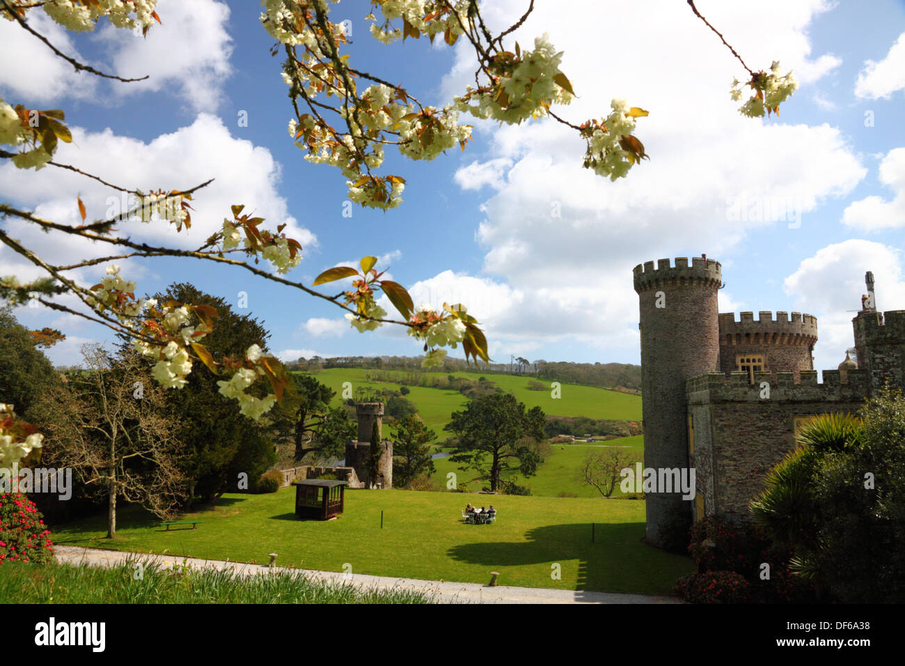 A Gothic castle with turrets, lawns, and cherry blossom Stock Photo - Alamy