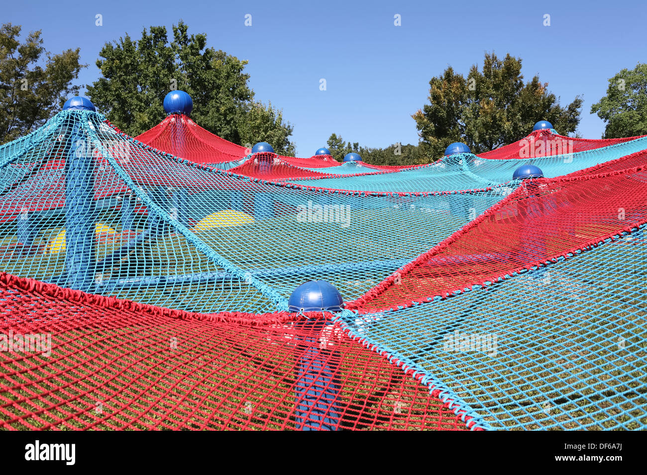 Blue and red spider net construction on kids playground Stock Photo - Alamy