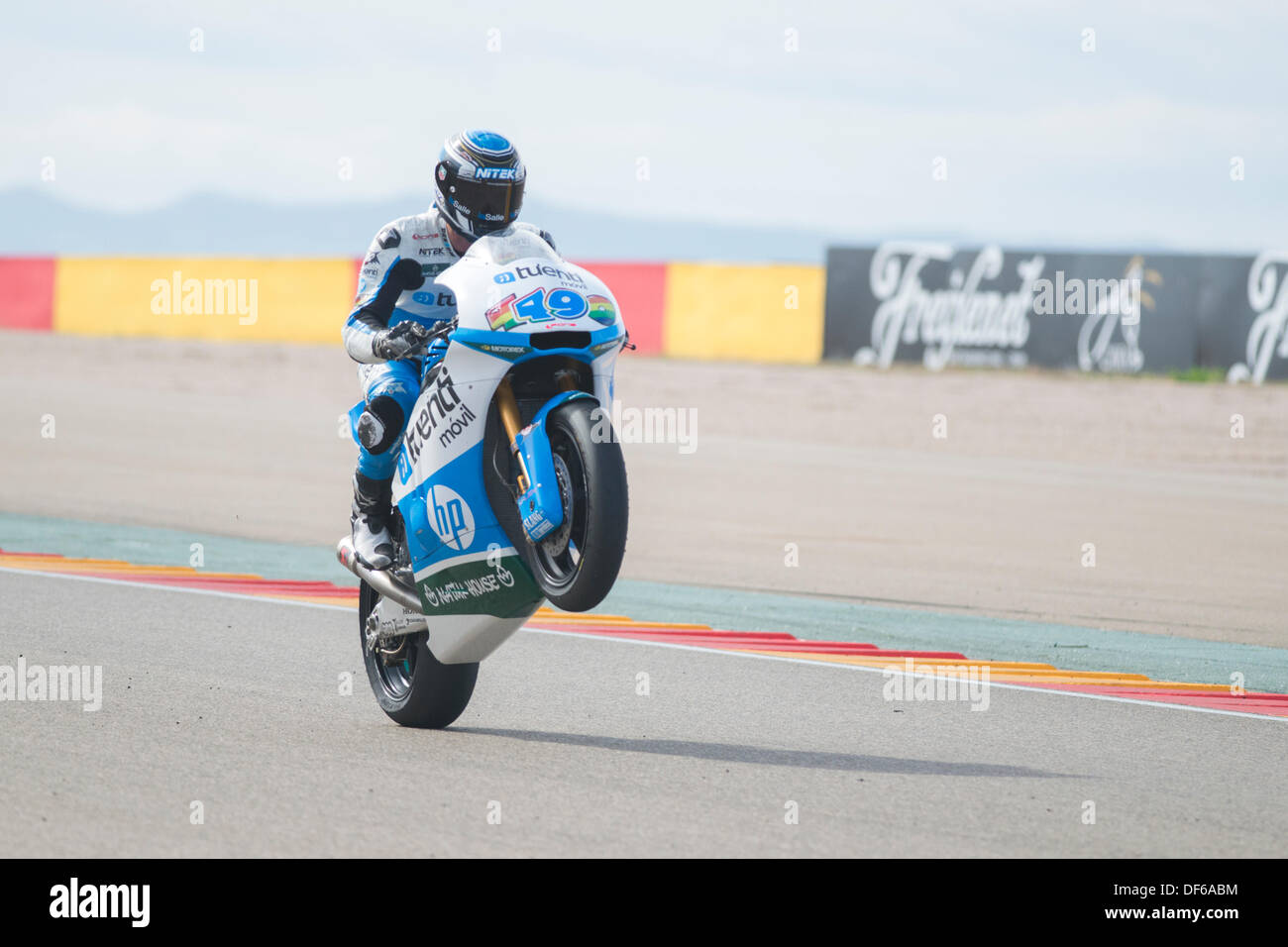 Spanish rider, Axel Pons, makes a wheelie while greeting the people ...