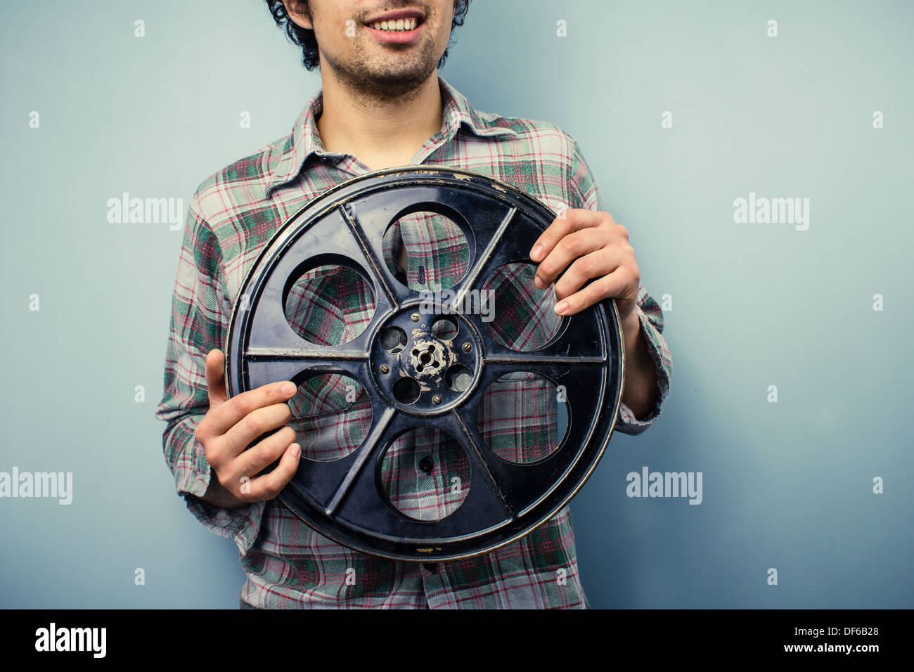 Young projectionist holding an old film reel Stock Photo - Alamy