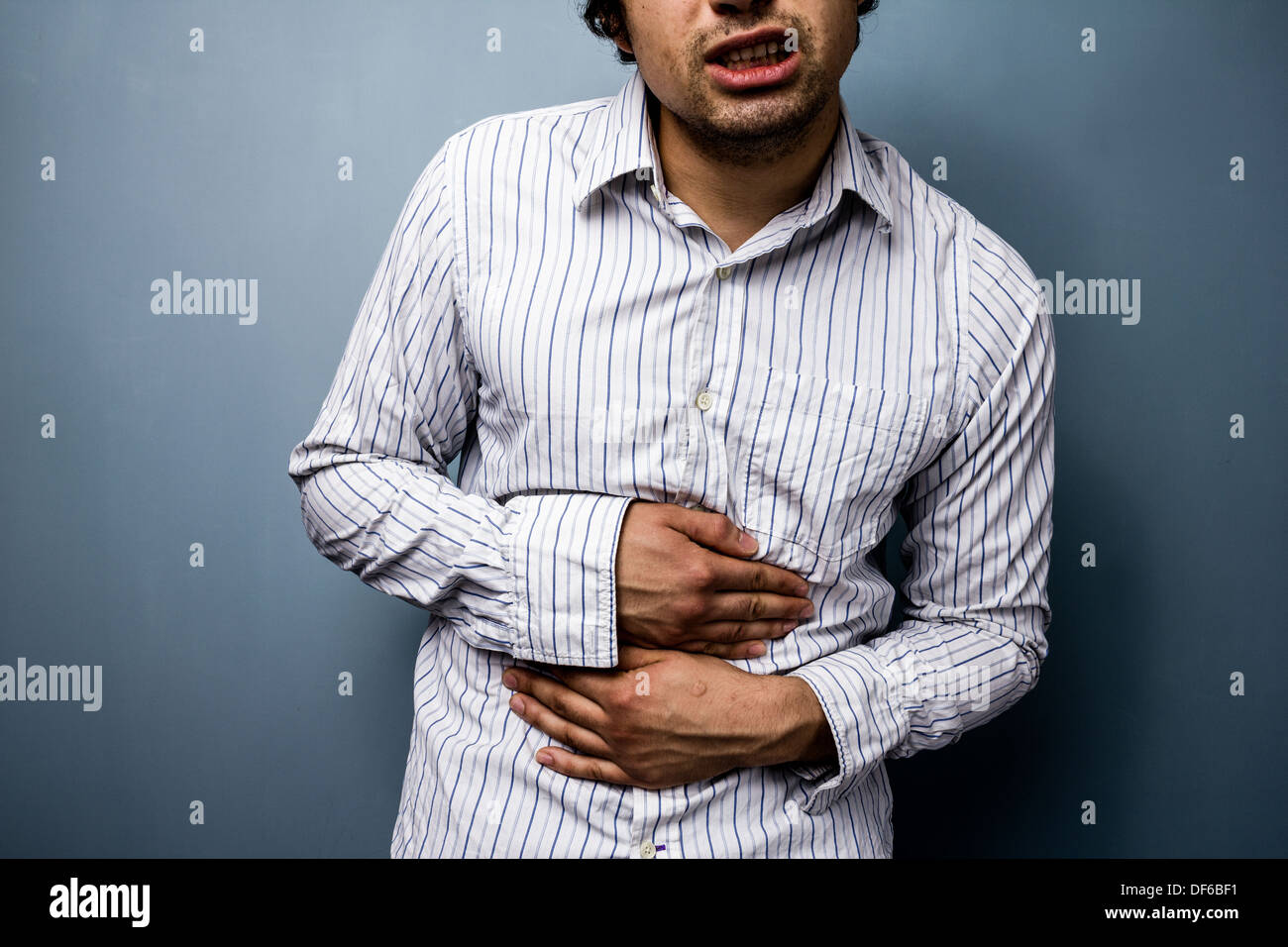 Young male stomach ache standing hi-res stock photography and images ...