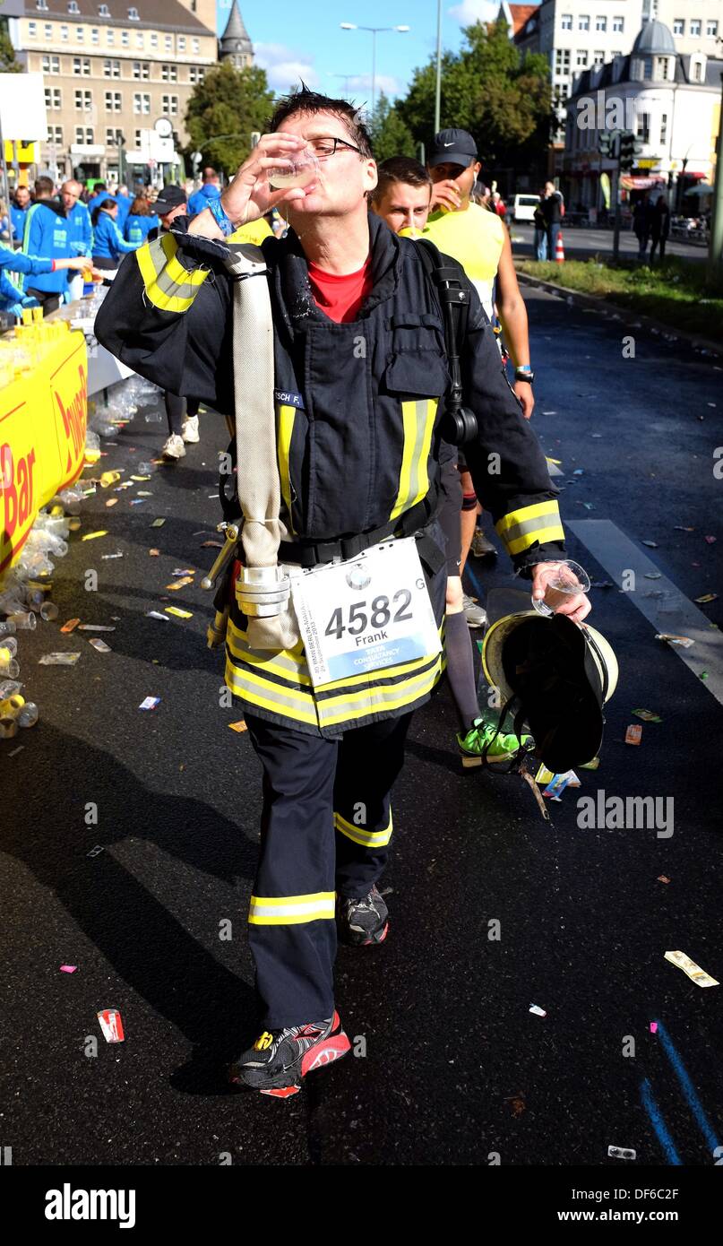 Berlin, Germany. 29th Sep, 2013. A man dressed as a fireman drinks at a ...