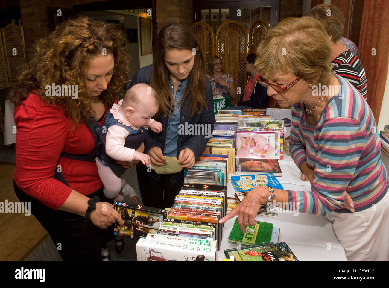 Visitors browsing book and DVD stall at a Macmillan Cancer Support ...