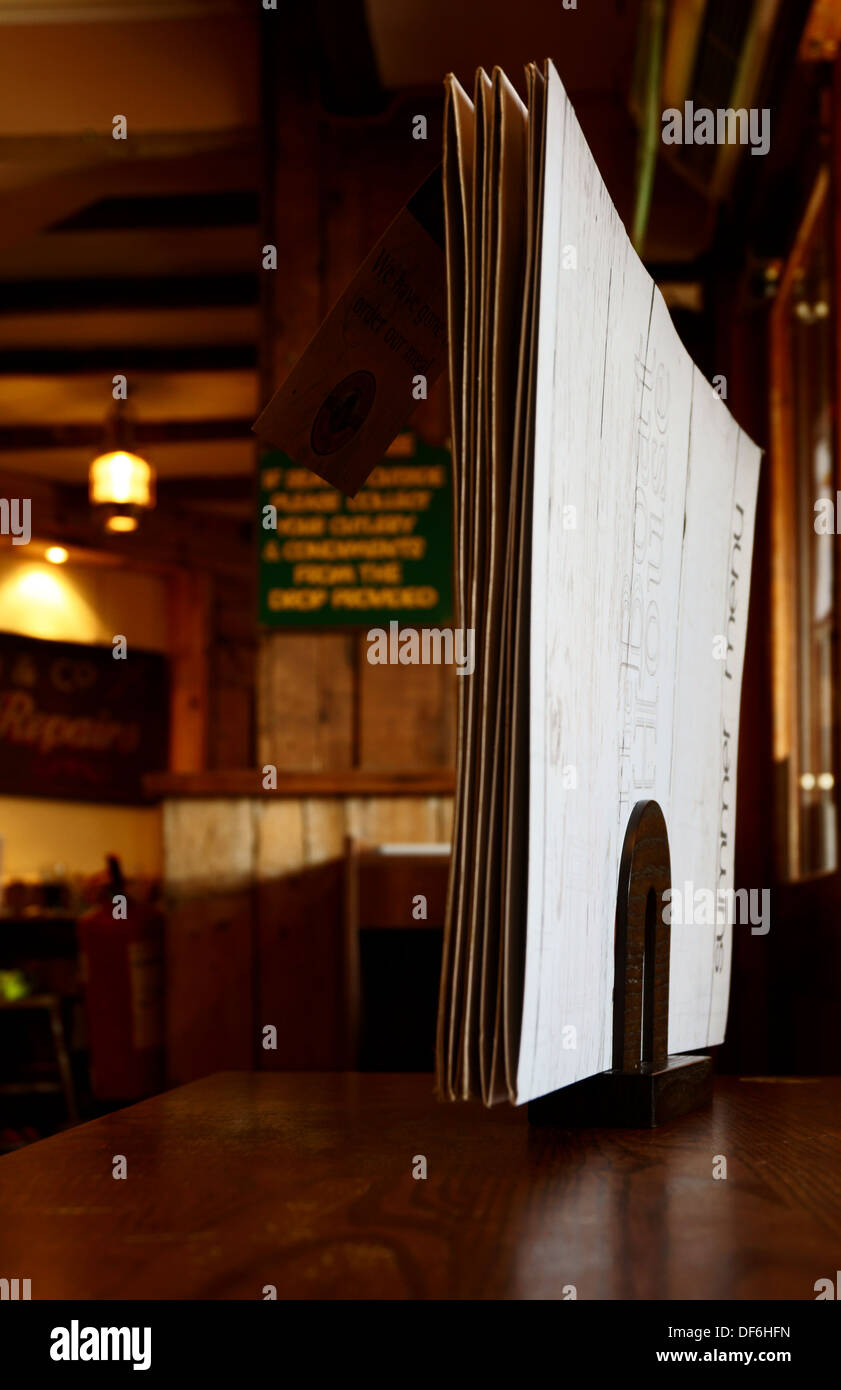Food menus stacked in a holder on a wooden table in a restaurant Stock ...