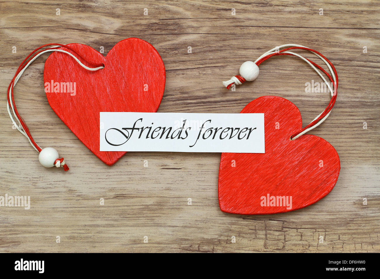 Friends forever card with two red wooden hearts Stock Photo - Alamy