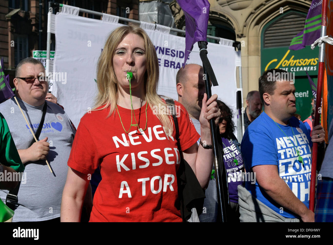 A young woman wears a t-shirt saying 'Never Kiss A Tory' among the tens ...