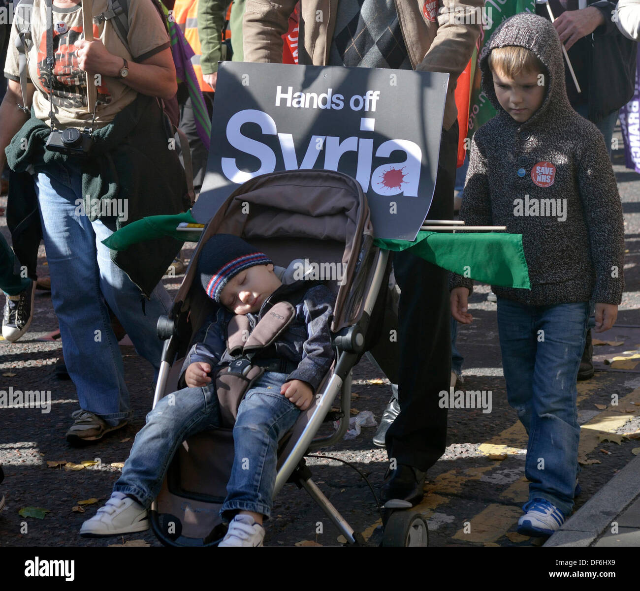 A child sleeps in his pushchair as tens of thousands protest during the ...