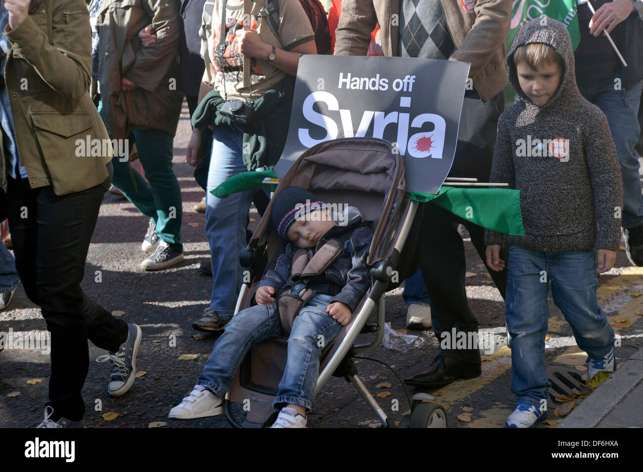 A child sleeps in his pushchair as tens of thousands protest during the ...