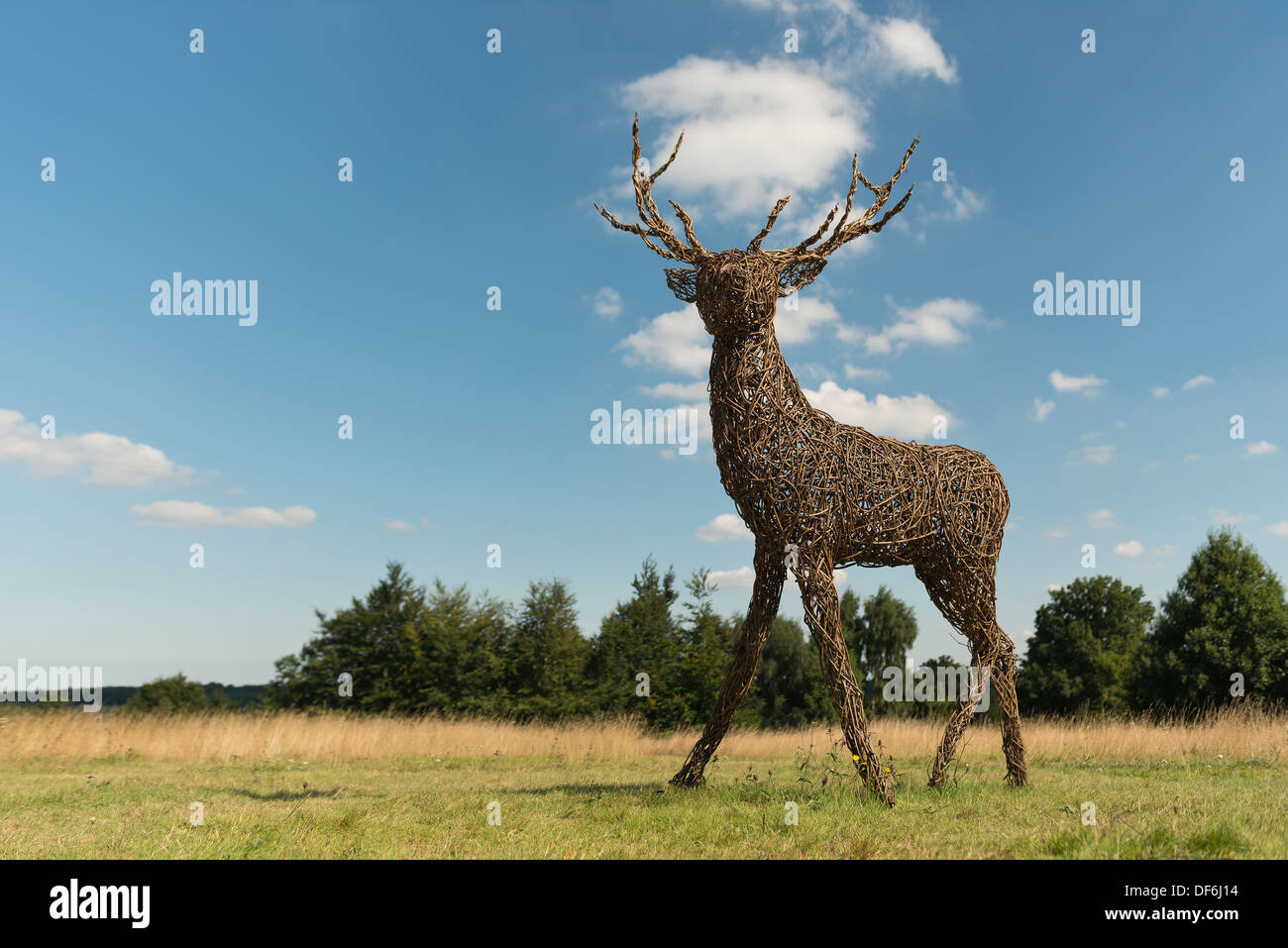 wicker work male deer stag in grass field summer complex sculpture on ...