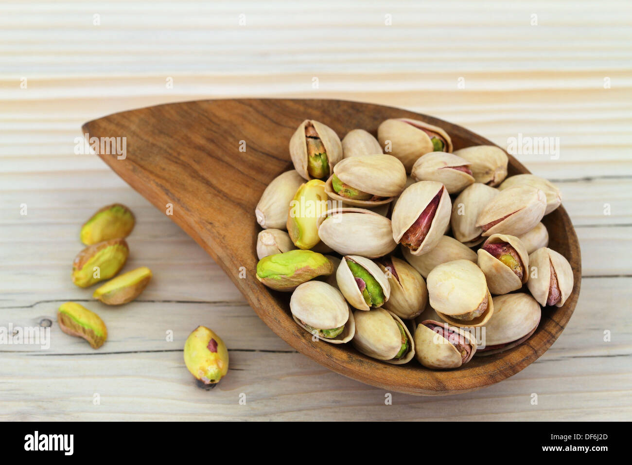 Pistachio nuts with and without shell in wooden bowl Stock Photo - Alamy