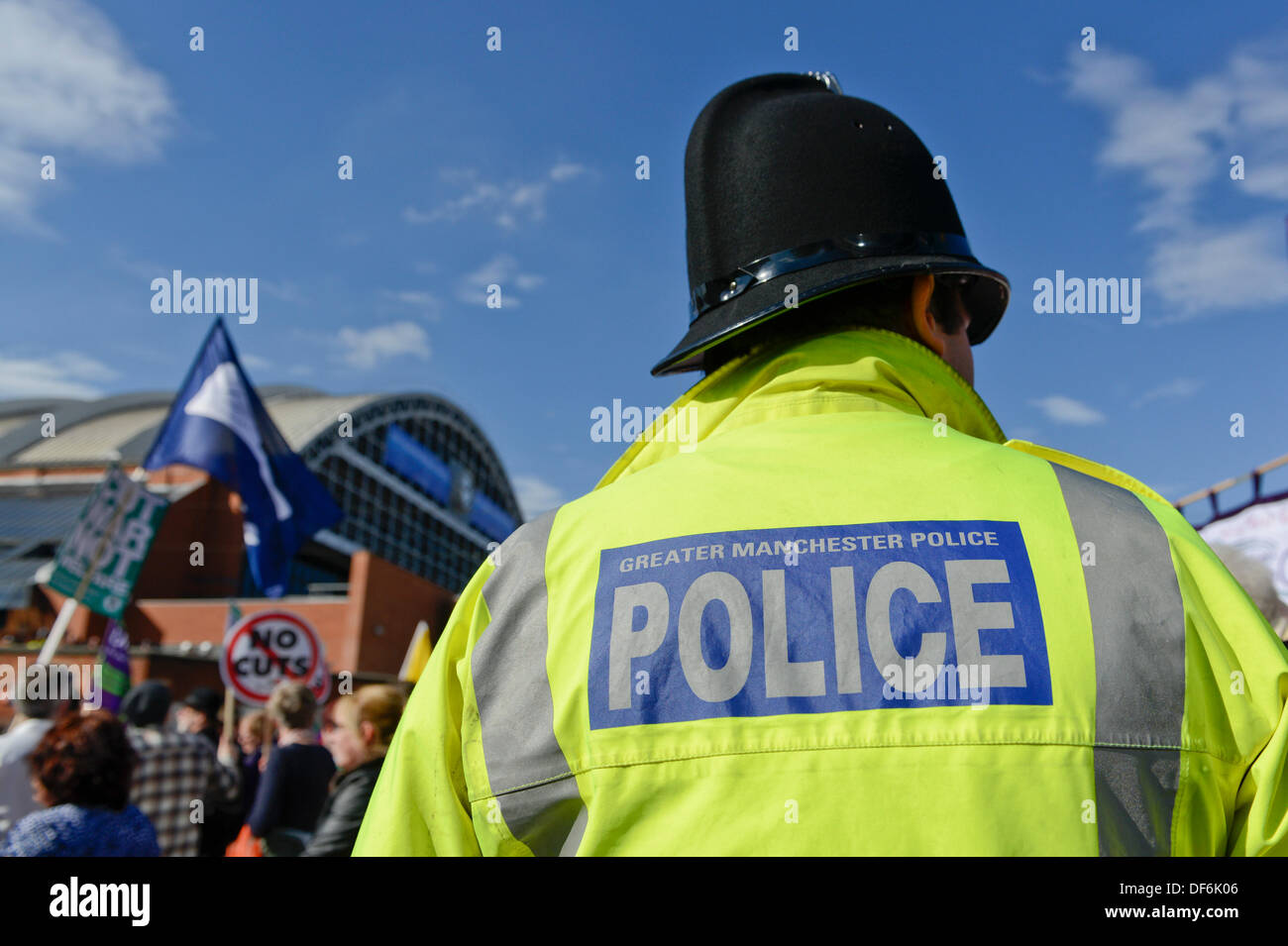 Manchester, UK. 29th Sept 2013. A policeman watches protestors near to ...