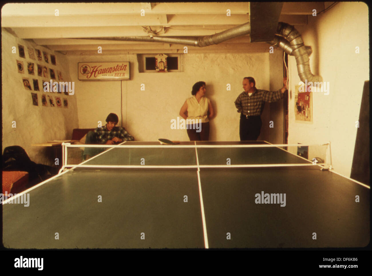 Mr. and Mrs. Wallace A. Wolf are shown in their basement recreation ...