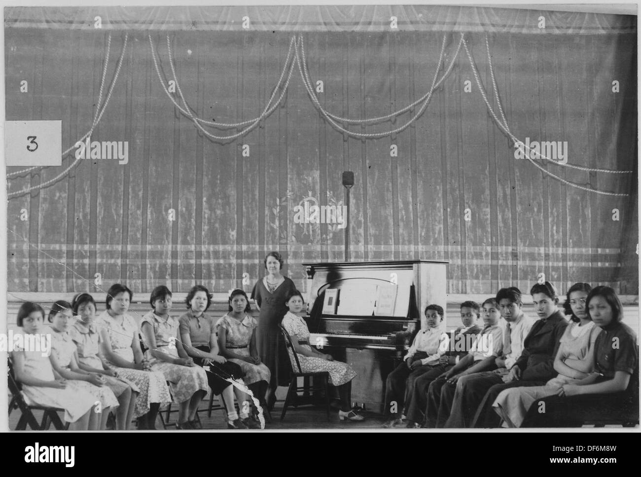 A group of students participate in a music class, engaging with ...