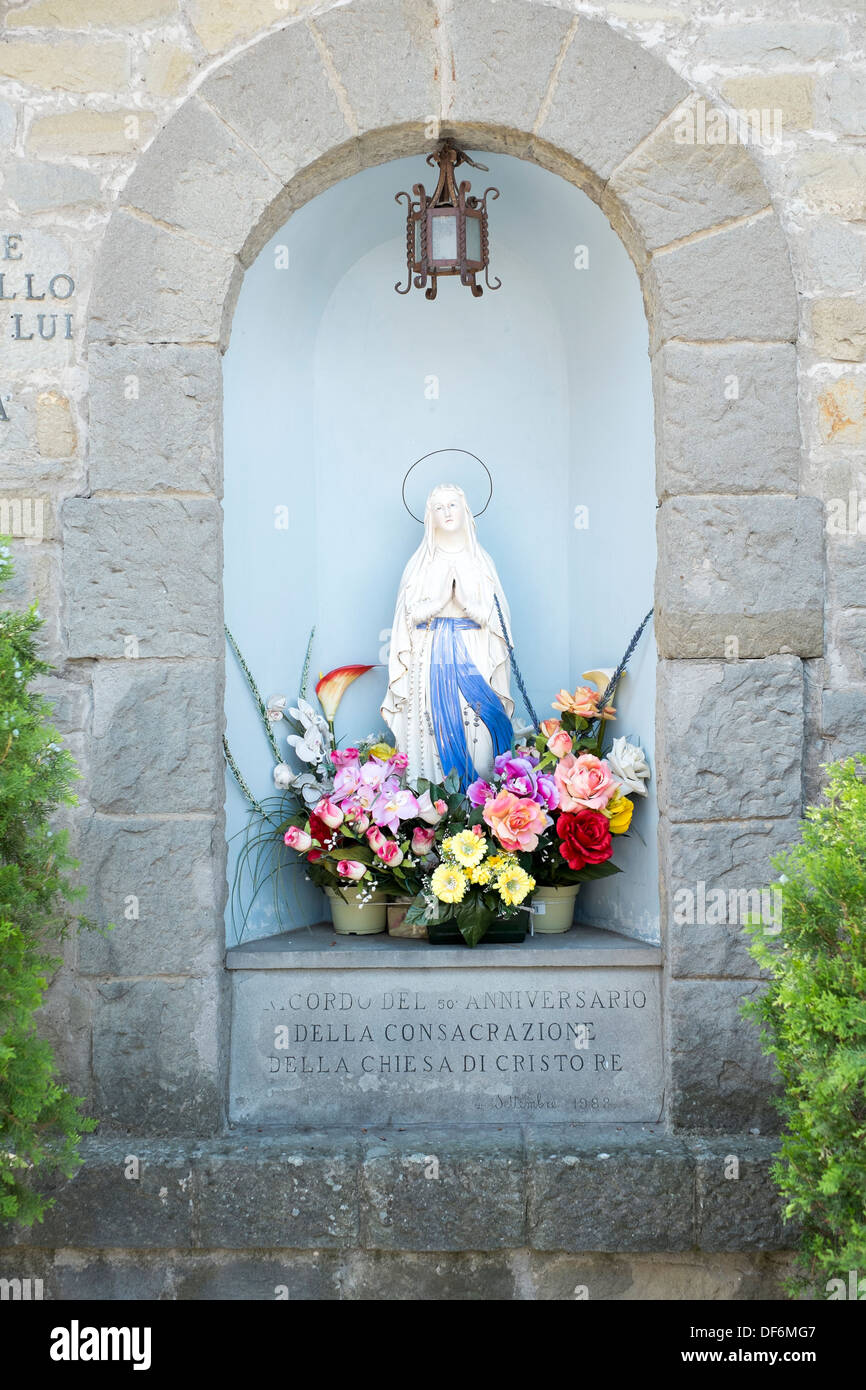Shrine to a female Saint surrounded by flowers in Tuscany Italy Stock ...