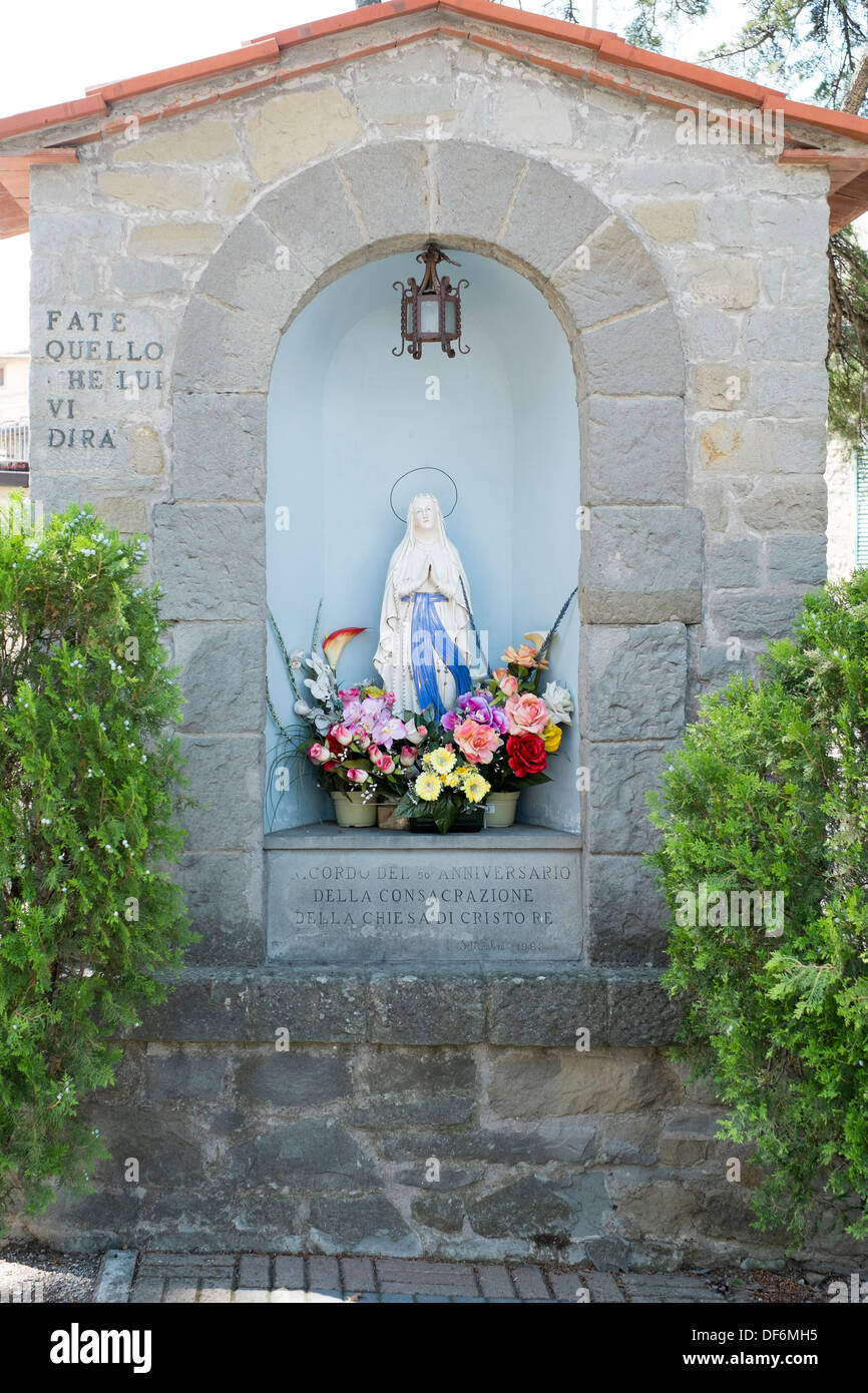 Italian shrine to Saint with flowers and porcelain statue of a woman in ...