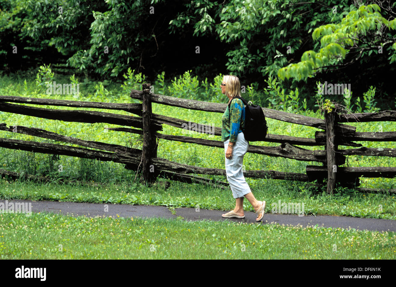 A visitor strolls through the William J. Carter Farm at Humpback Rocks ...