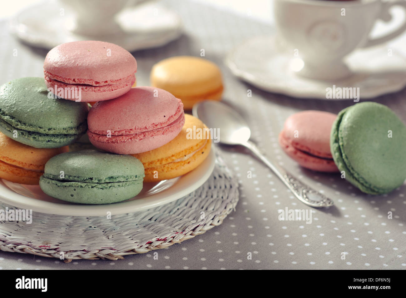 Traditional french pastry - macaroon with cup of tea on beige ...