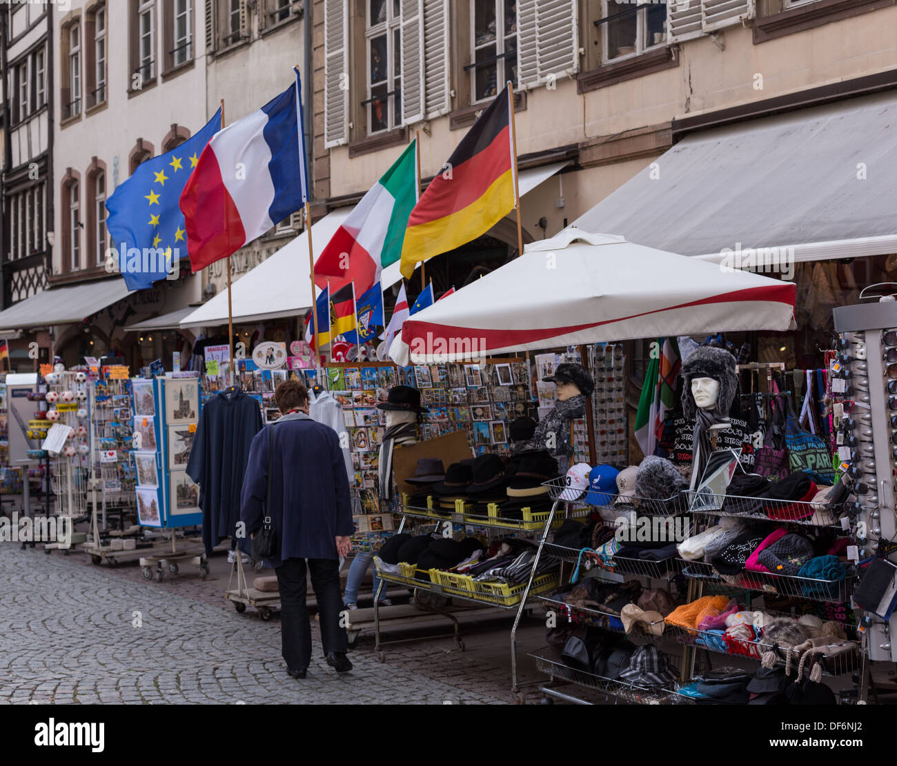 A tourist doing some souvenir shopping in the European union. The flags ...