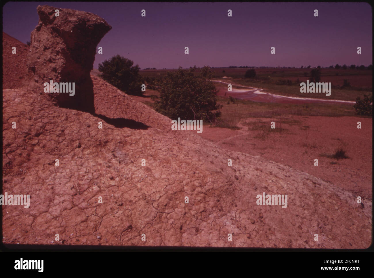 Red clay and shale mounds often feature oddly shaped outcroppings ...