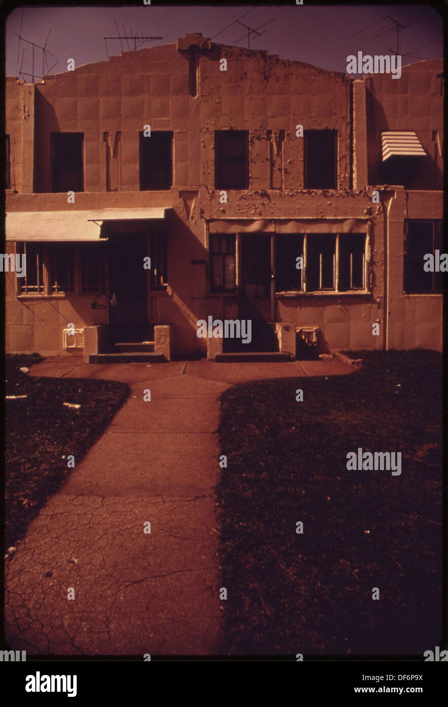 An image of an old row house with peeling paint, showing signs of age ...