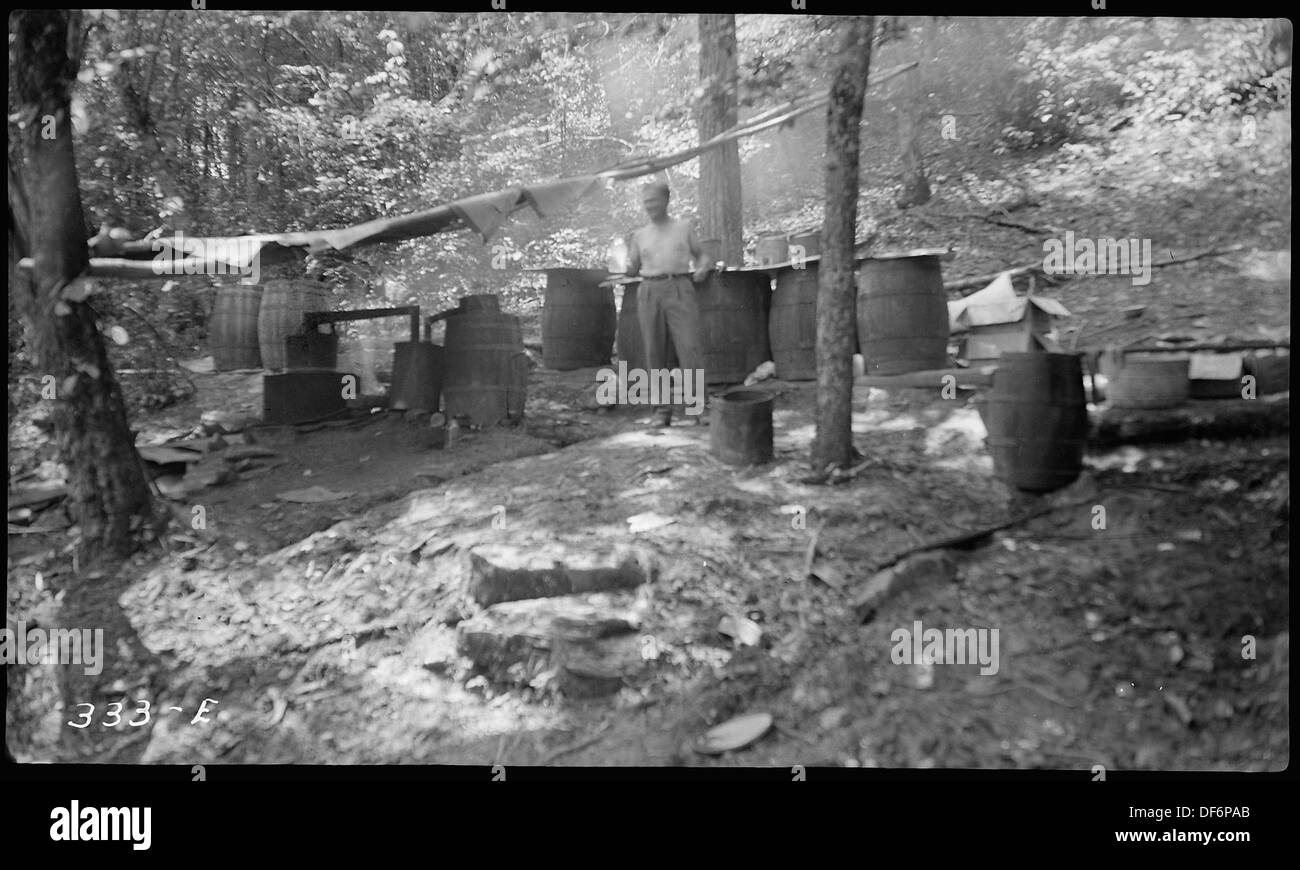 The image features an old still, traditionally used for distilling ...