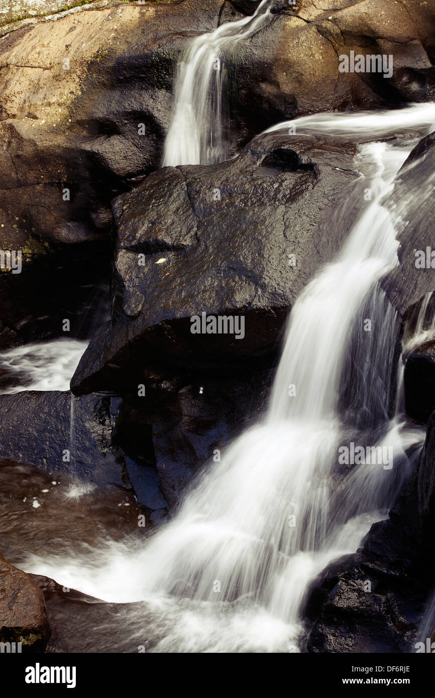 Two waterfalls flowing over rock Stock Photo - Alamy
