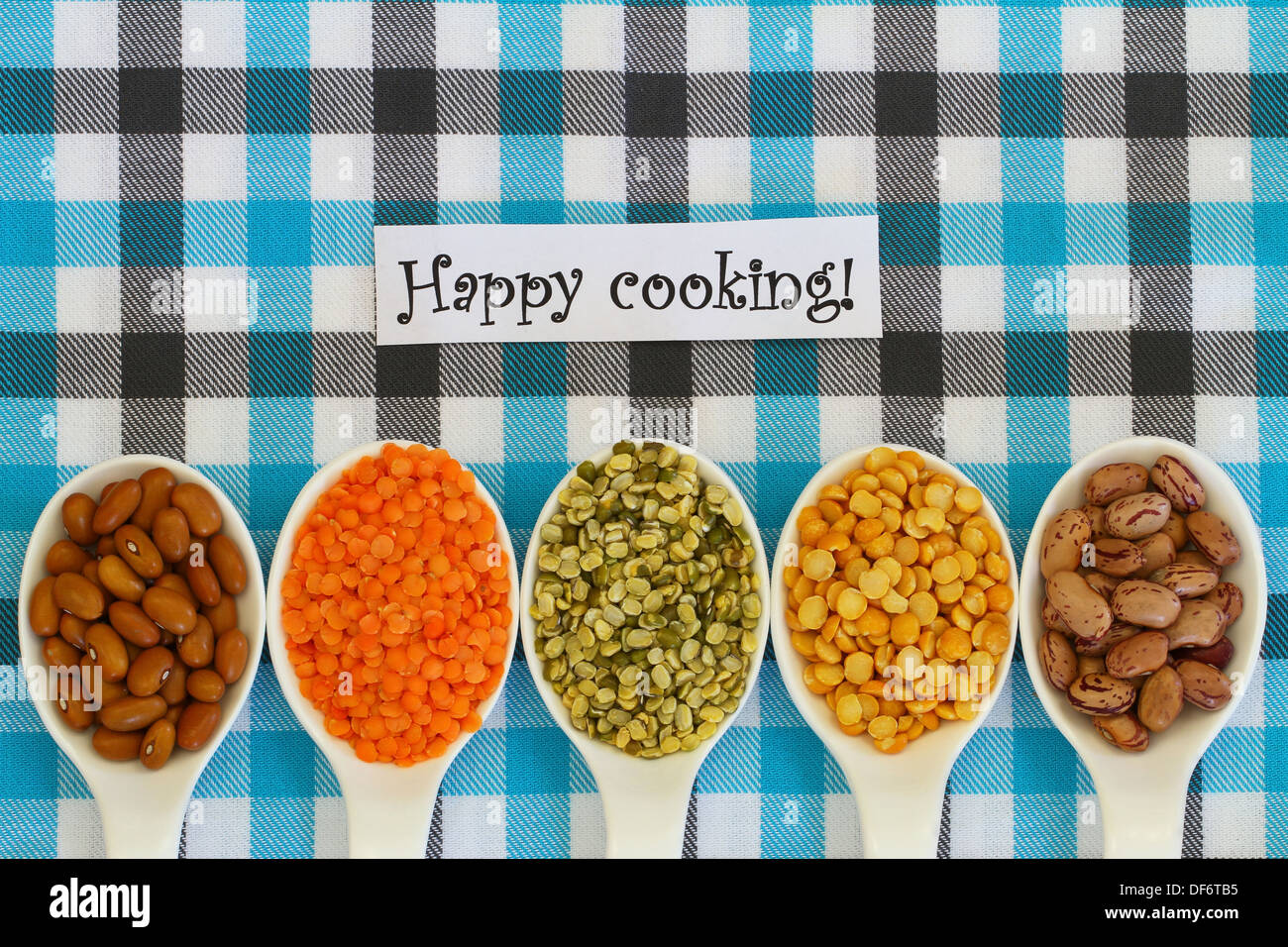 Happy cooking card with selection of pulses on porcelain spoons on ...